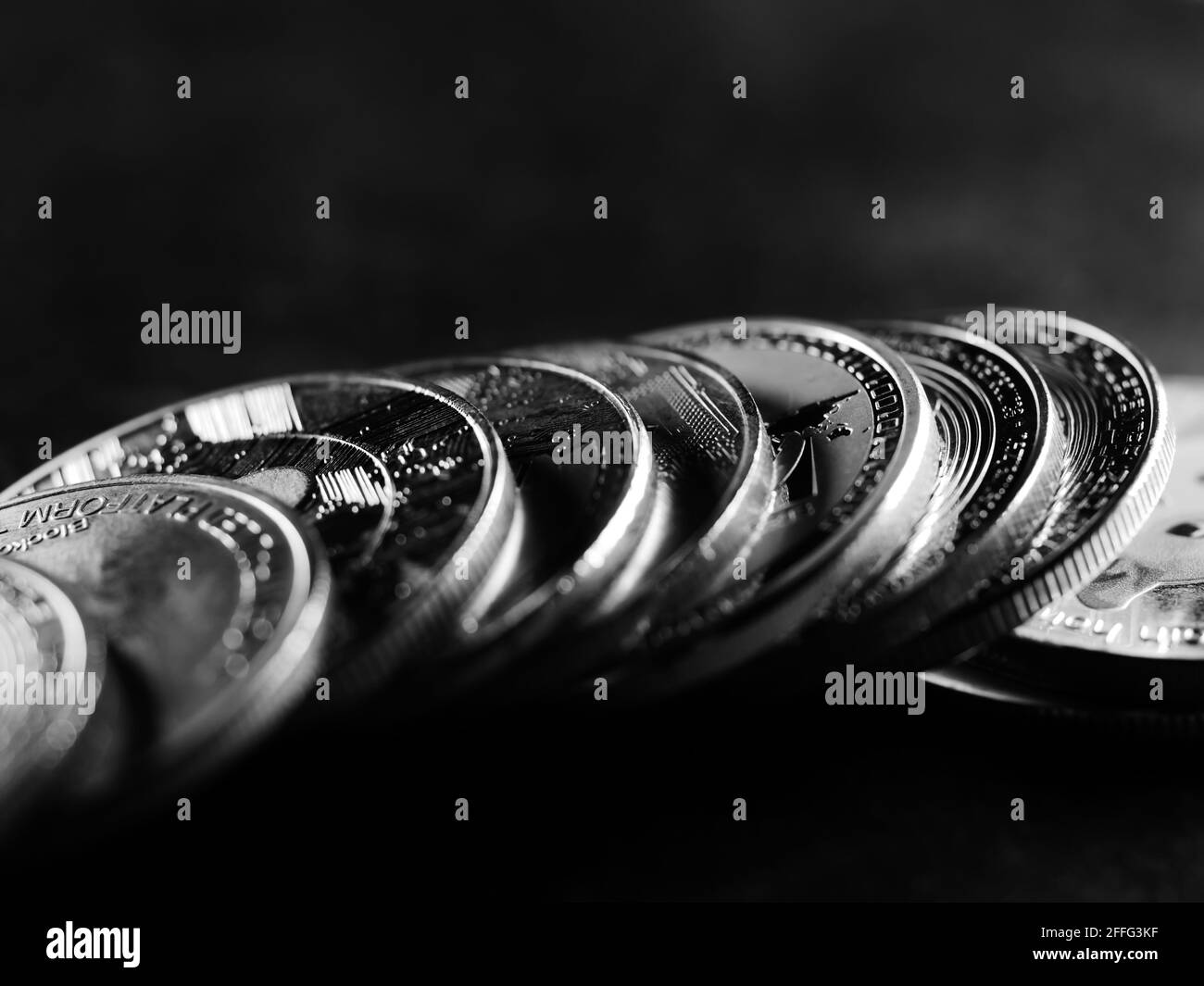 Grayscale shot of gold and silver crypto currencies Stock Photo - Alamy