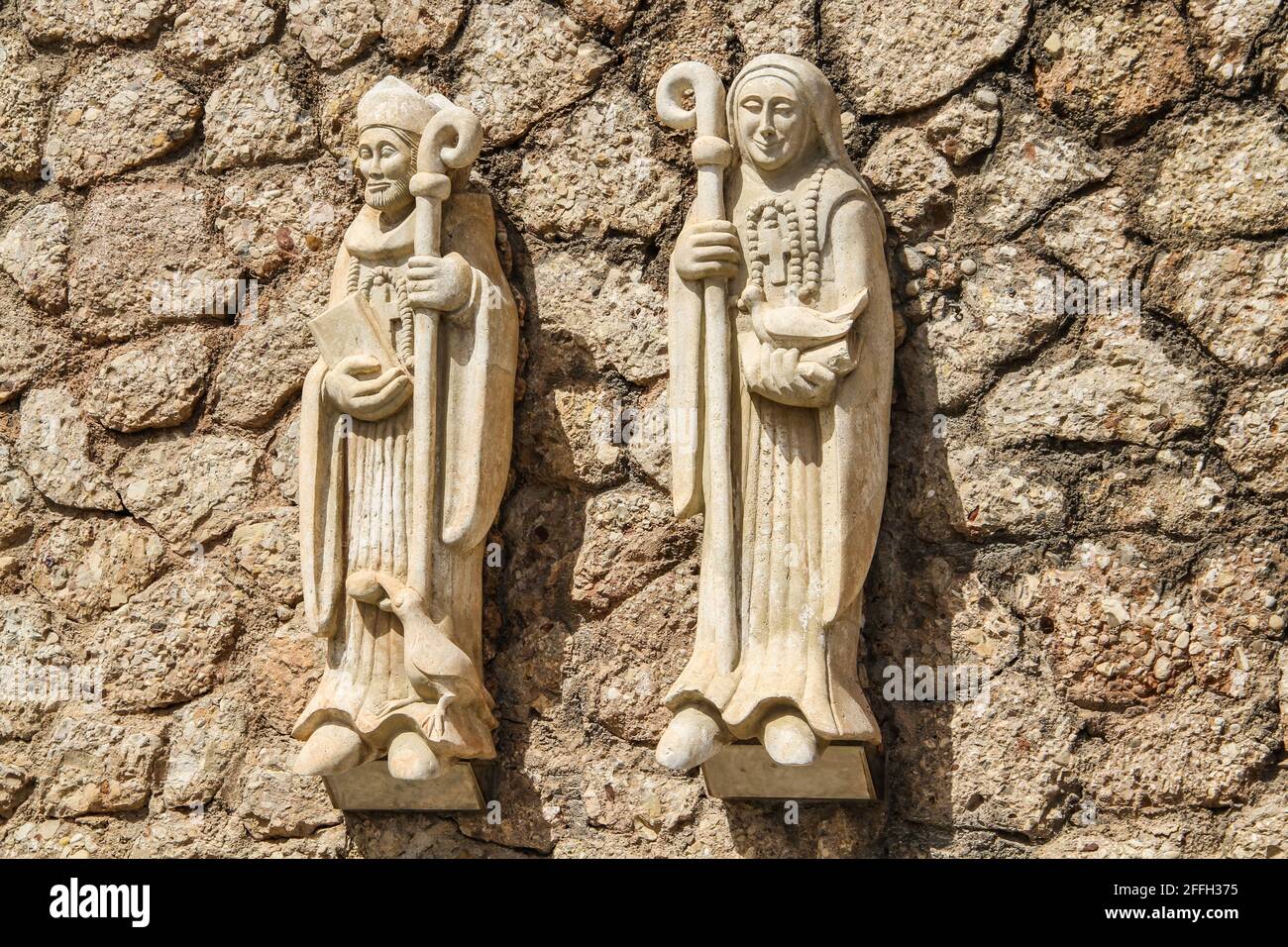 Sculpture of a monk and a nun on the wall of a mountain monastery in ...