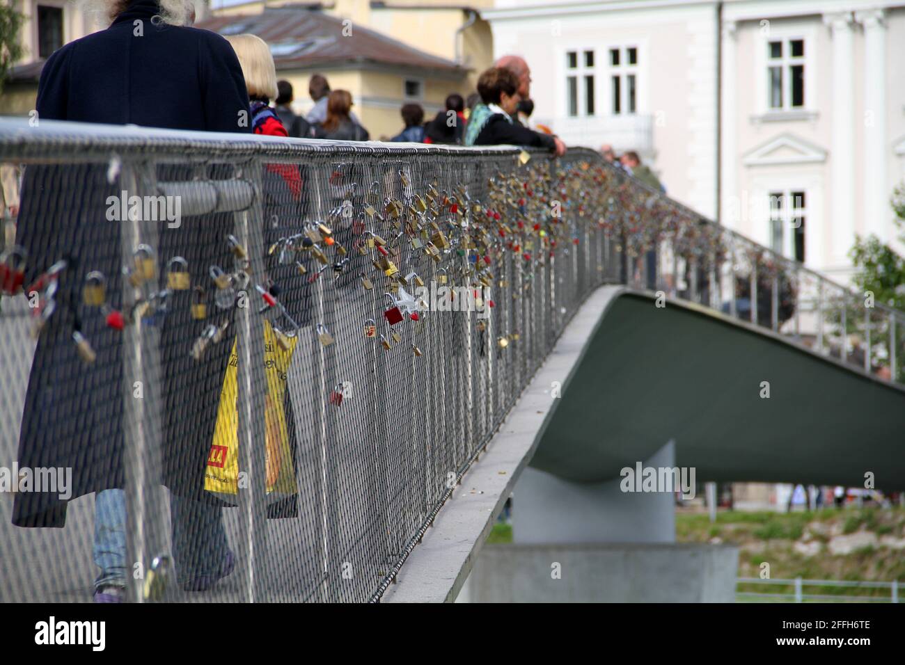 The railings of the bridge are hung with door locks that represent the ...