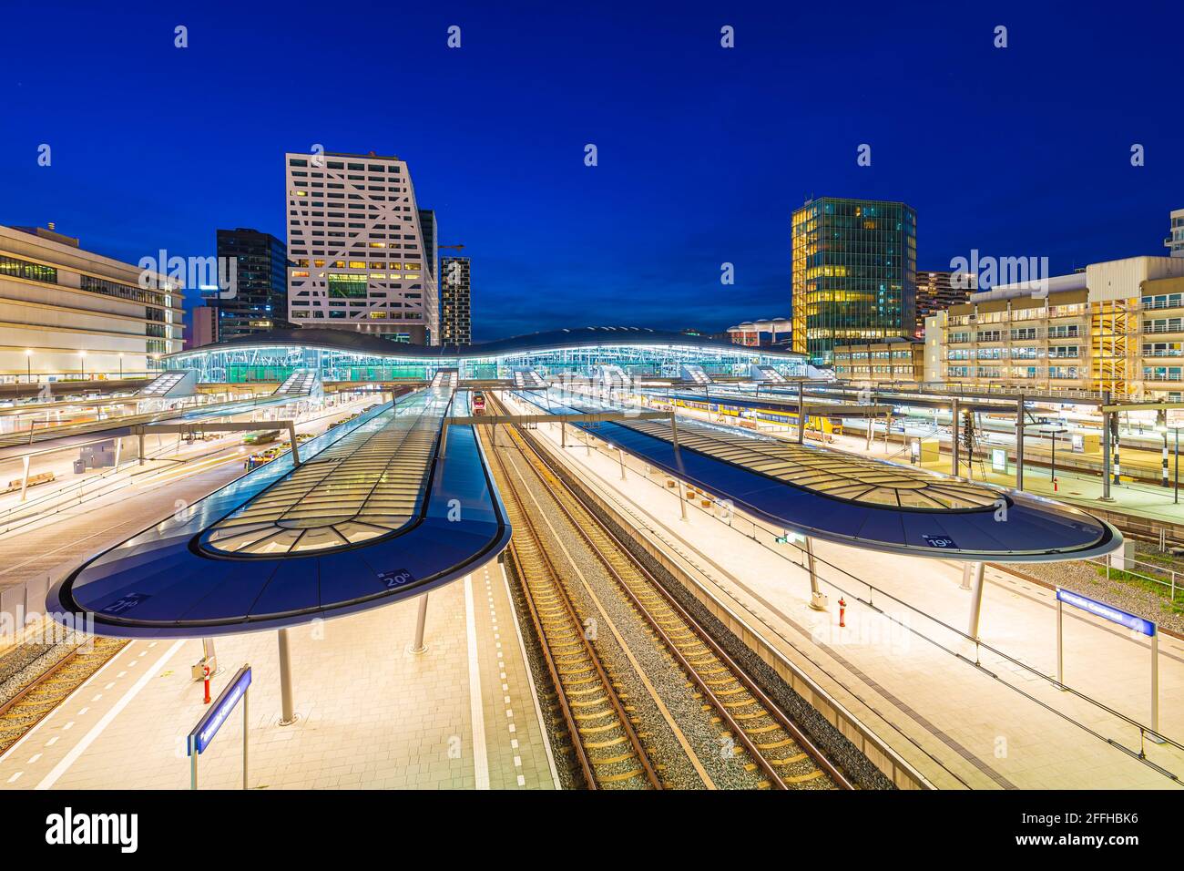 Utrecht central railway station at dusk. Modern contemporary ...