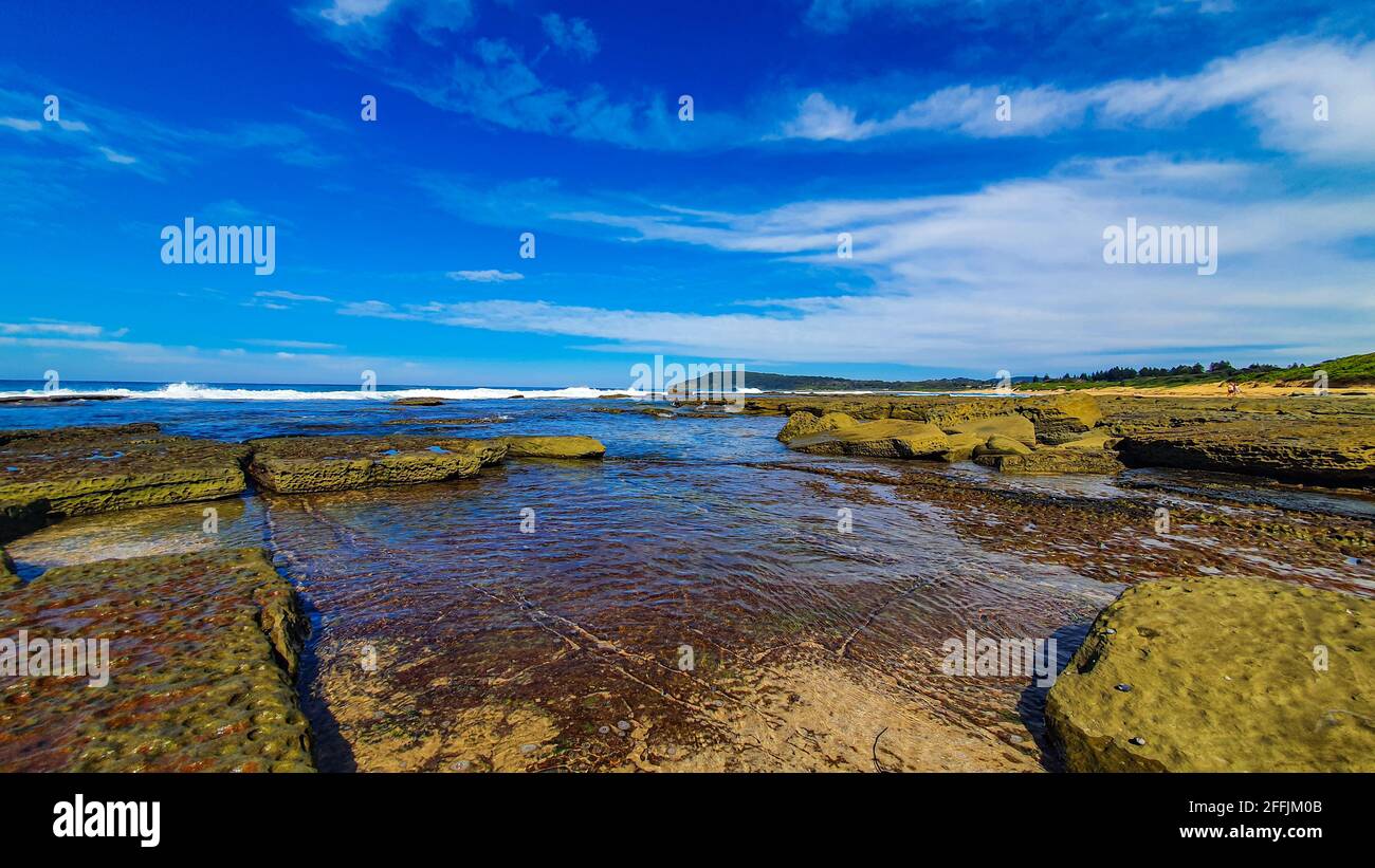 Wet flat surface on the rocky beach Stock Photo - Alamy