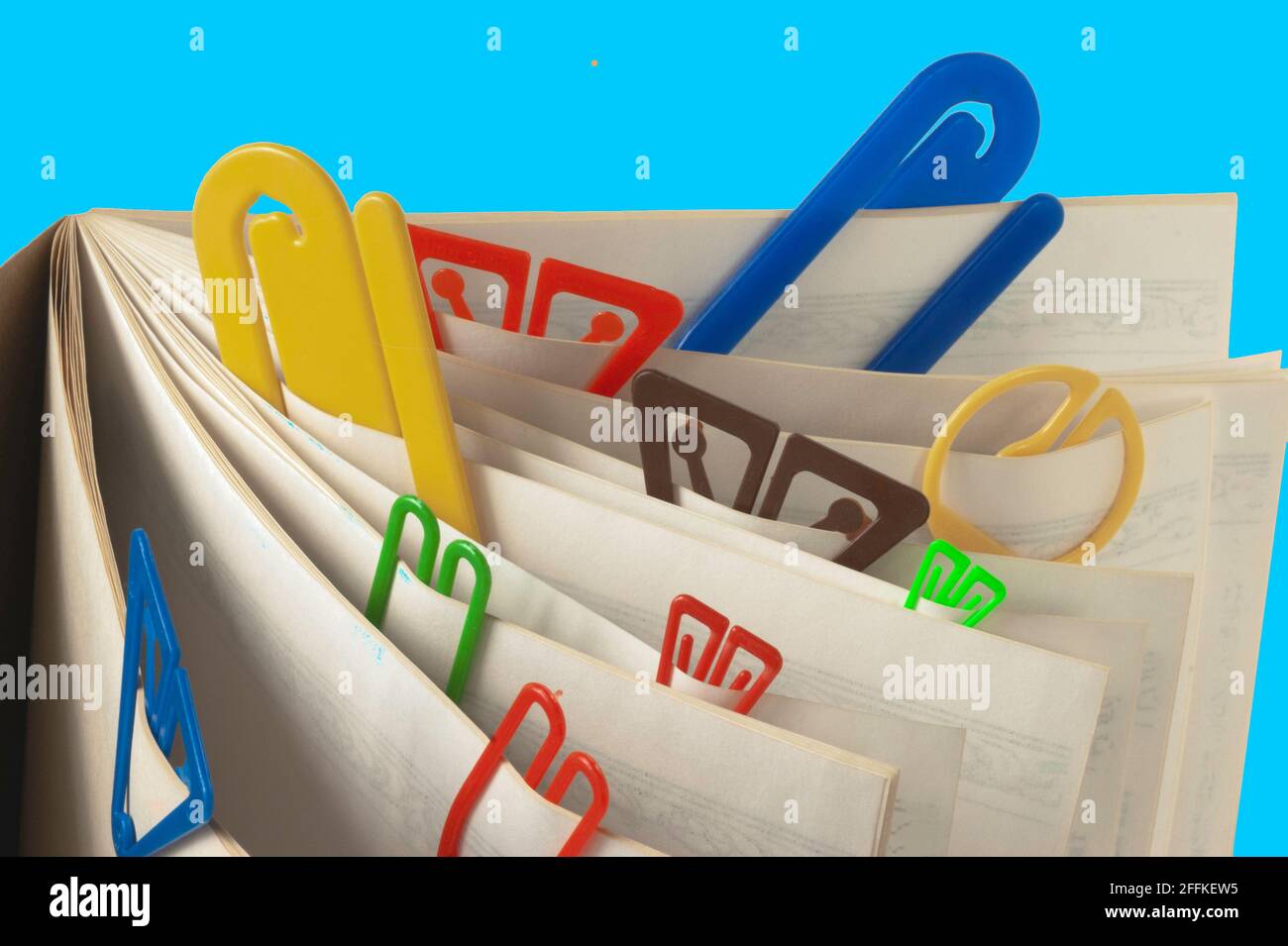 Close up isolated image of 10 paperclips separating pages in a book or ...