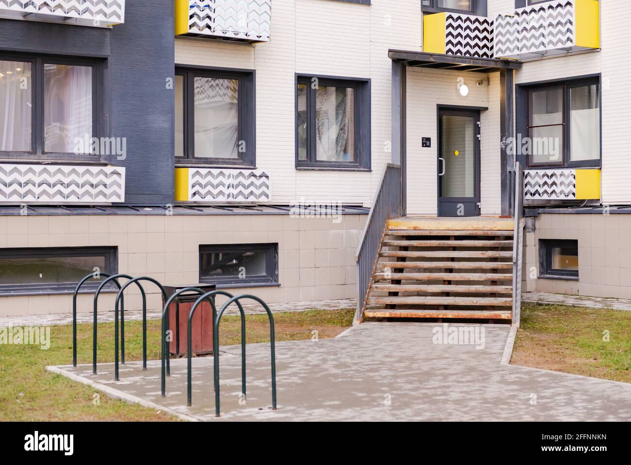 Entrance to a new apartment building. Entrance with bicycle parking and ...