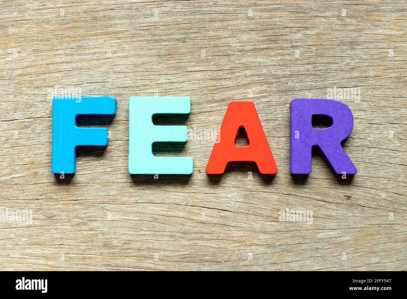 Color alphabet letter in word fear on wood background Stock Photo - Alamy