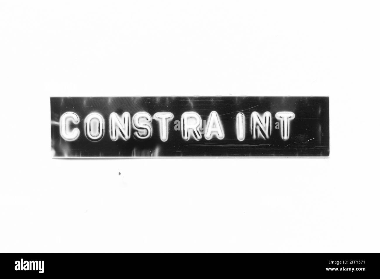 Embossed letter with word constraint in black banner on white paper ...