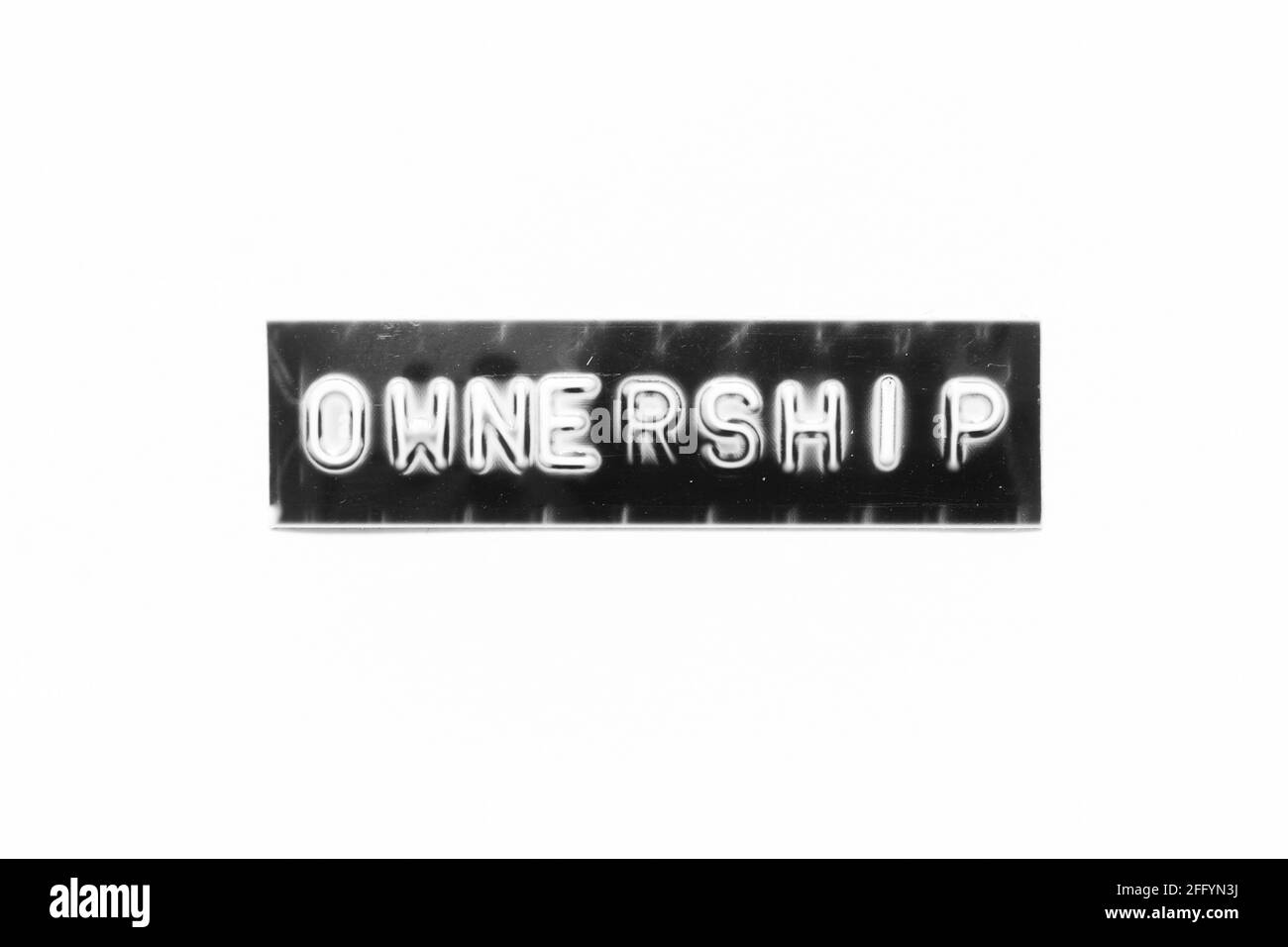 Embossed letter with word ownership in black banner on white paper ...