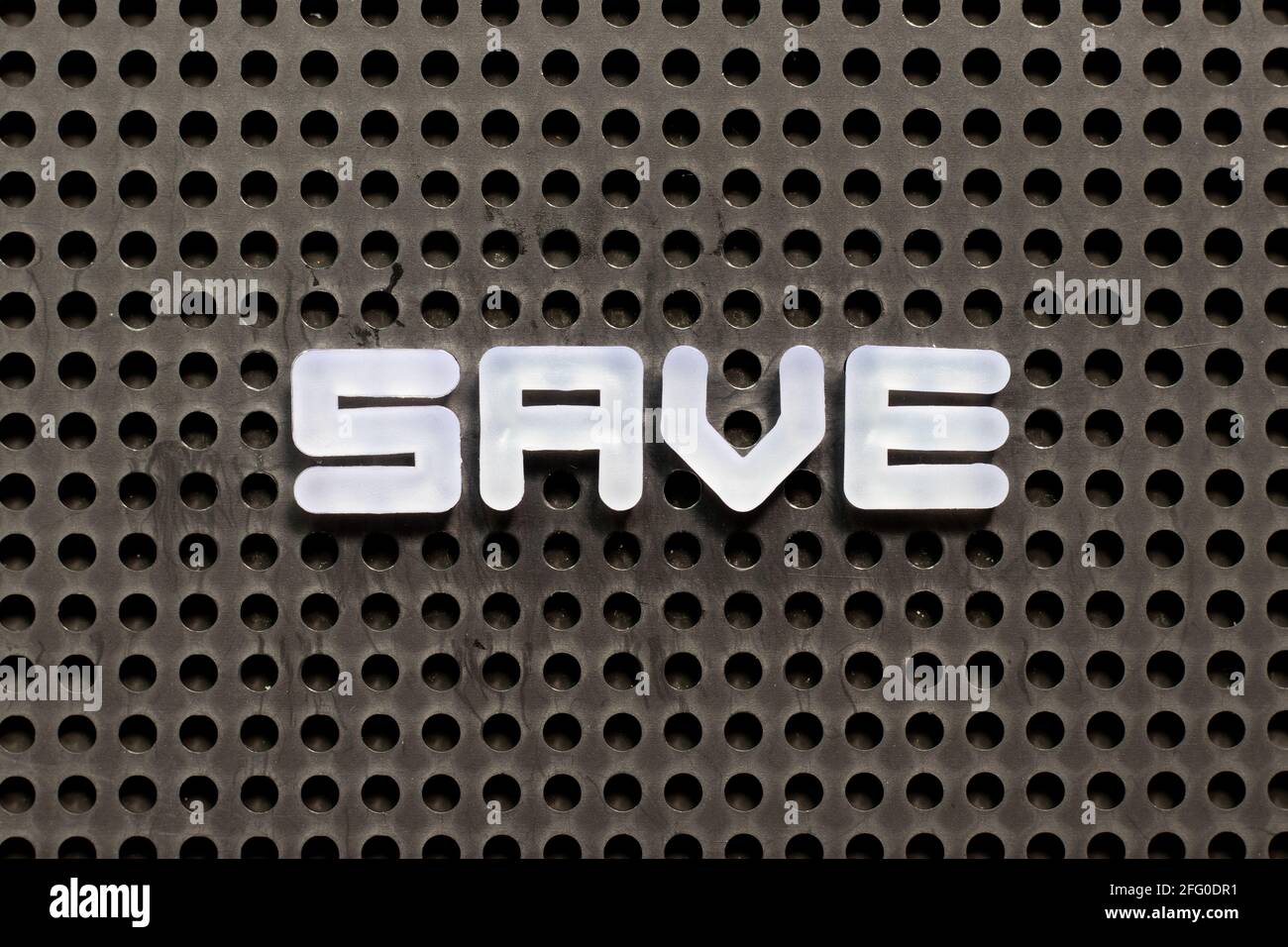 White color letter in word save on black pegboard background Stock ...