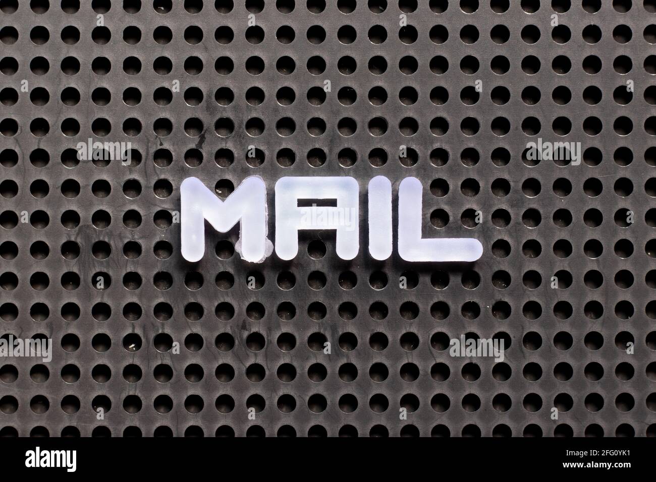 White color letter in word mail on black pegboard background Stock ...