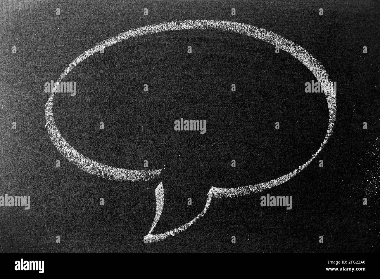 White color chalk hand drawing in round bubble speech shape with blank ...