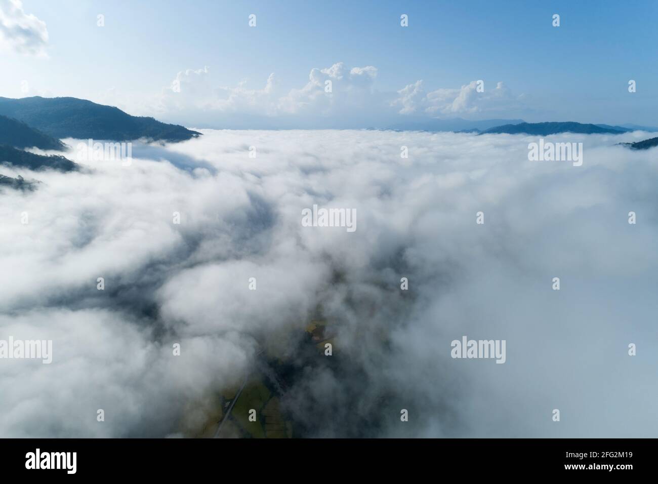 Aerial view drone shot of flowing fog waves on mountain tropical ...