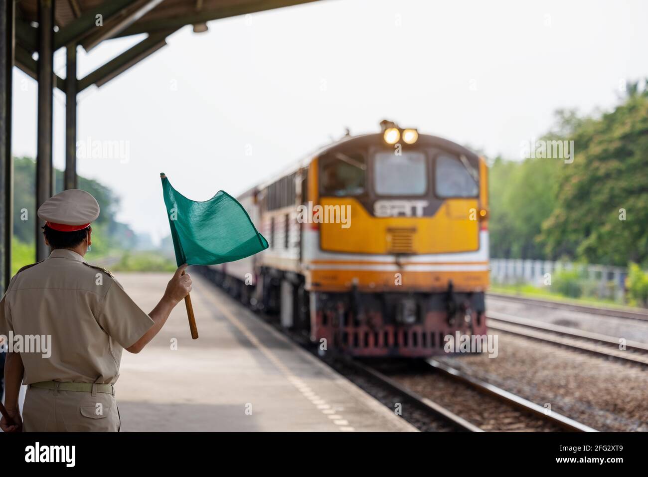 Selective focused, green flag raised up by officer for safety symbol to ...