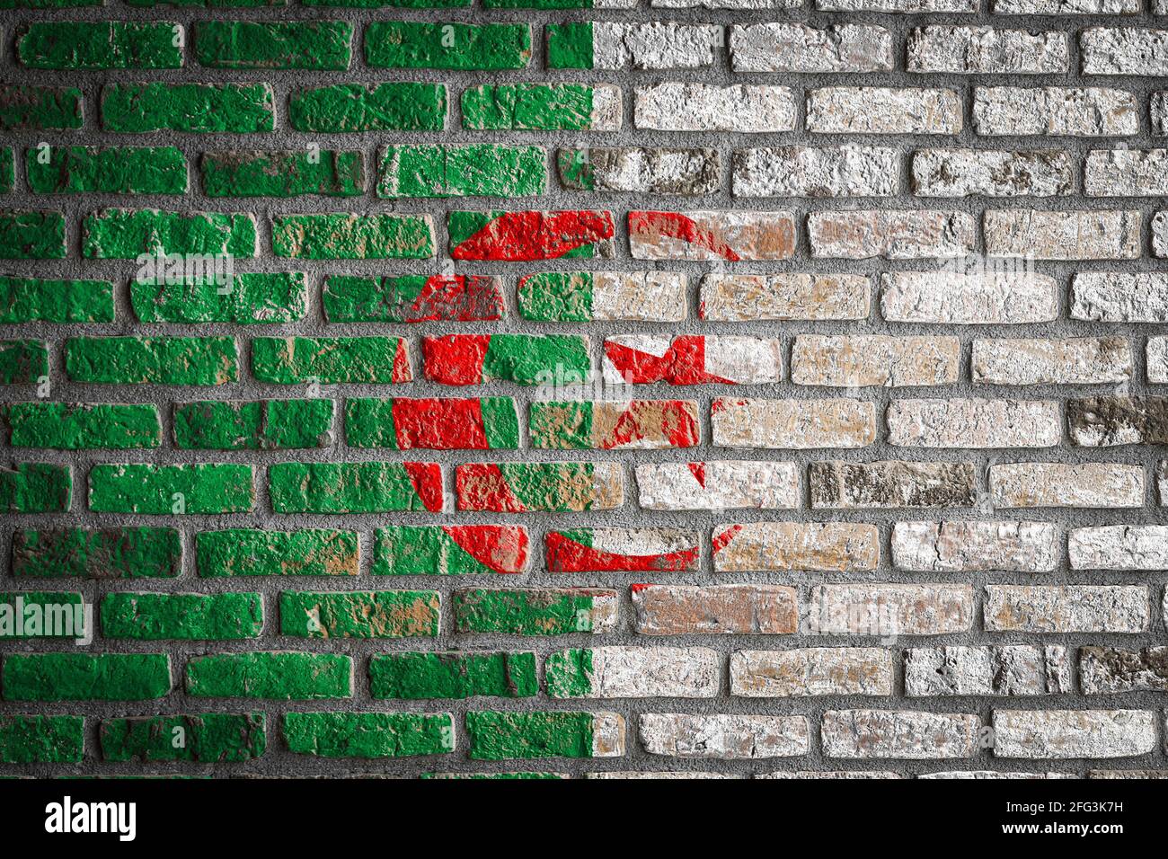 National flag of Algeria depicting in paint colors on an old brick wall ...