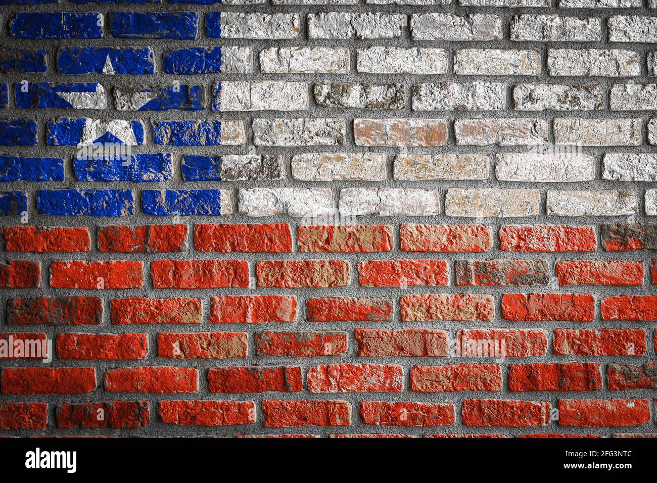 National flag of Chile depicting in paint colors on an old brick wall ...