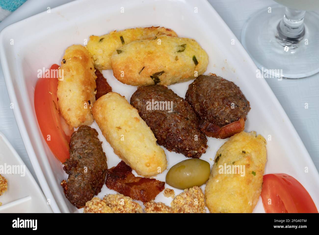 Food mix of various ingredients including rice balls meat balls ...