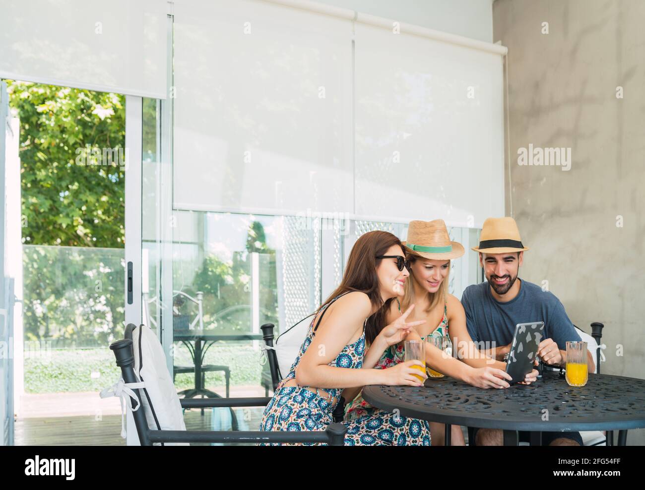 Three travelers friends at the hotel Stock Photo - Alamy