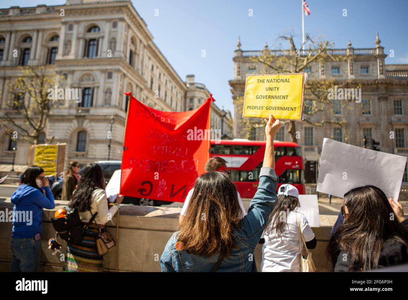 A protester holds a placard saying The National Unity Government People ...