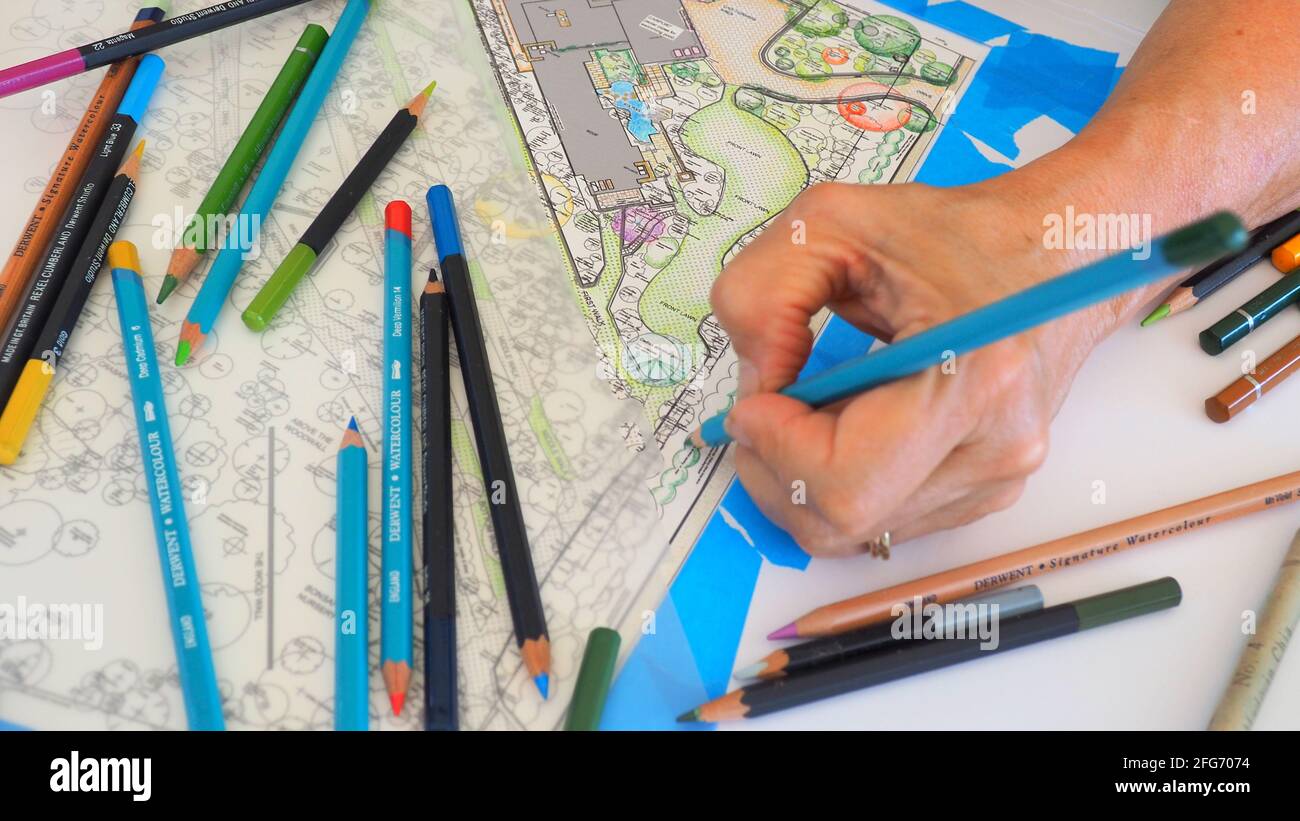 A left-handed artist uses pencils to hand-colour her landscape design ...