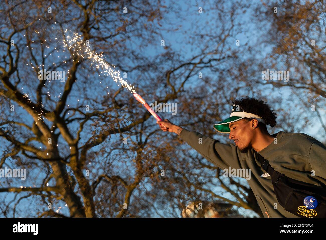 London, UK. 24th Apr, 2021. A man waving a fire cracker after ...