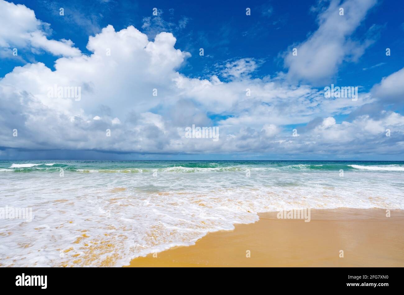 Beautiful sandy beach with wave seafoam clashing on sandy shore ...
