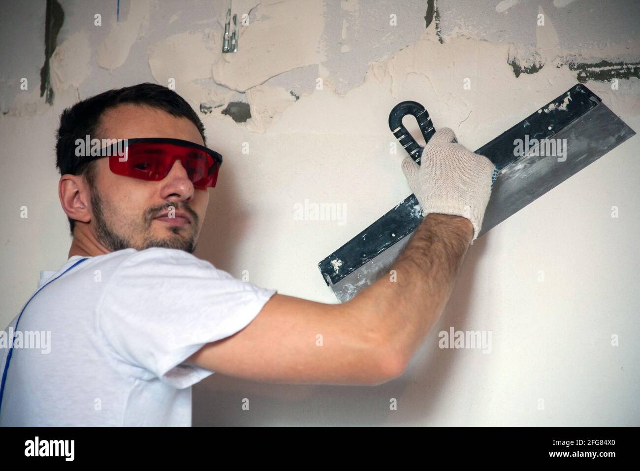 work on finishing the walls with mixtures of plaster and putty when ...