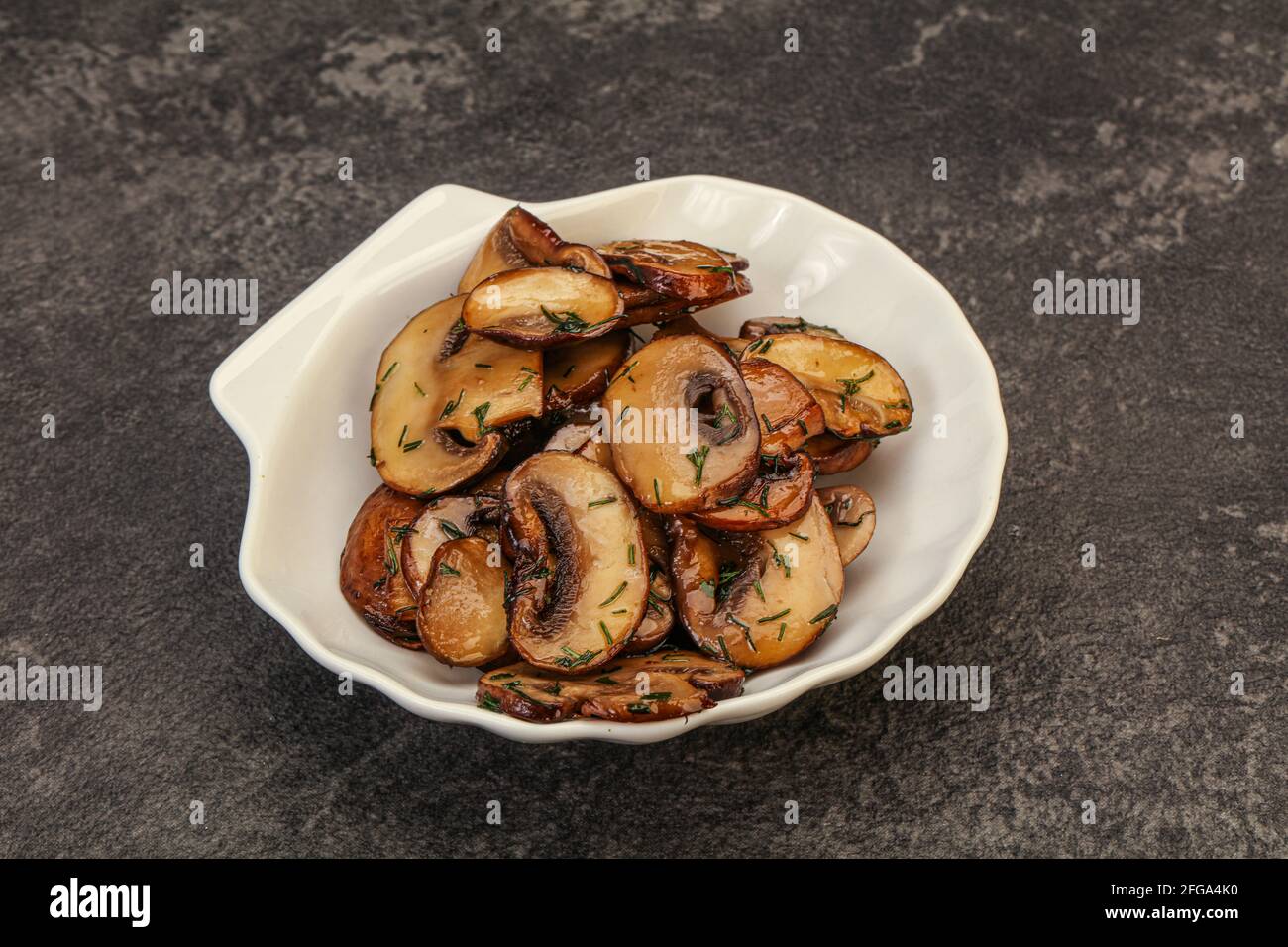 Roasted champignon with herbs and spices in the bowl Stock Photo - Alamy