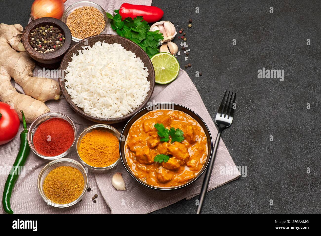Plate of Traditional Chicken Curry, rice and spices on dark concrete ...