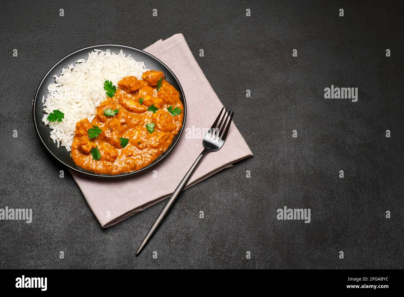 Plate of Traditional Chicken Curry and rice on dark concrete background ...