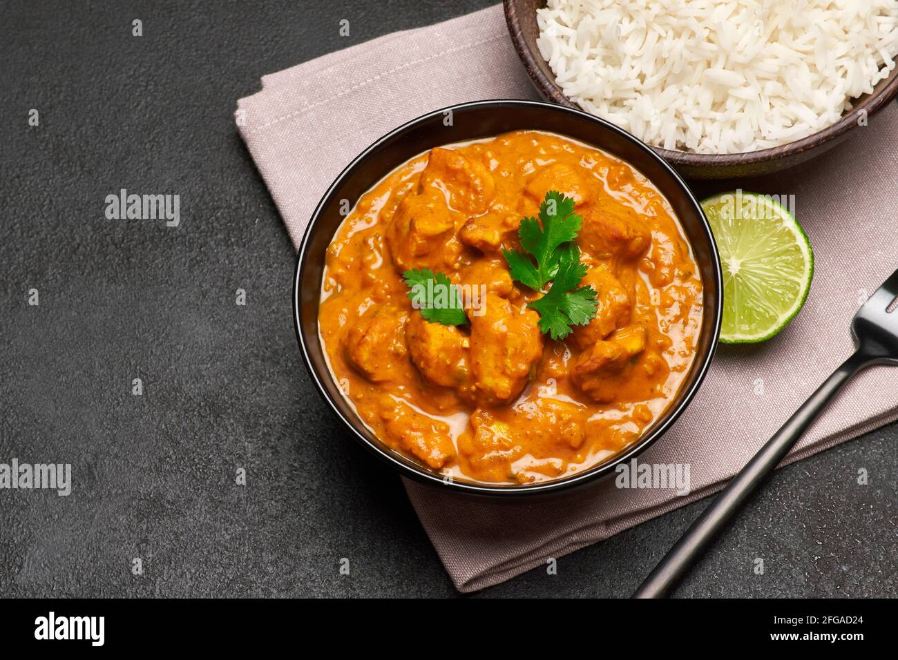 Plate of Traditional Chicken Curry and rice on dark concrete background ...
