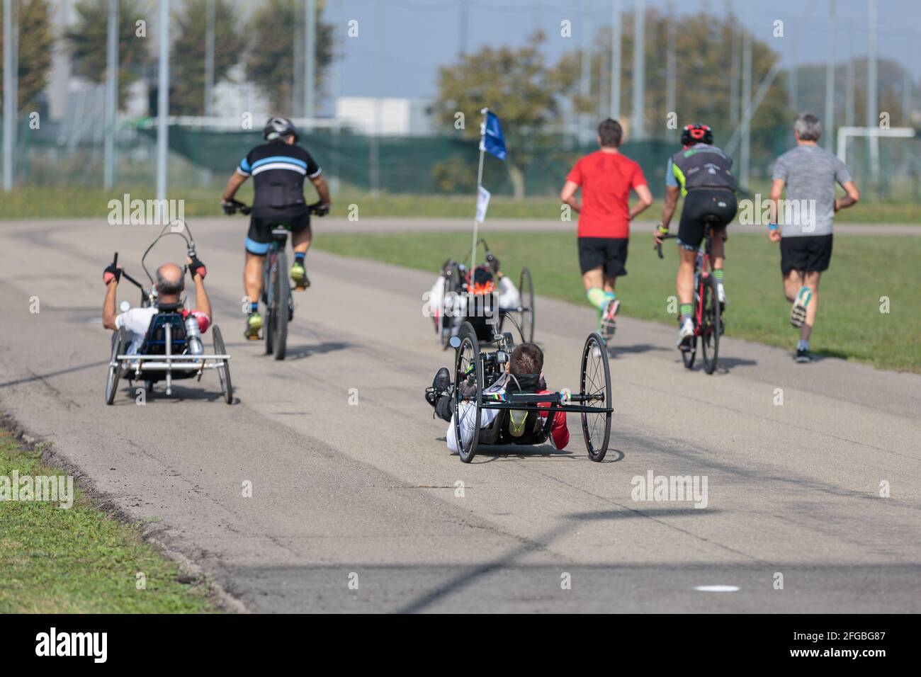 Disabled Athletes training with their Hand Bikes with Cyclist and ...