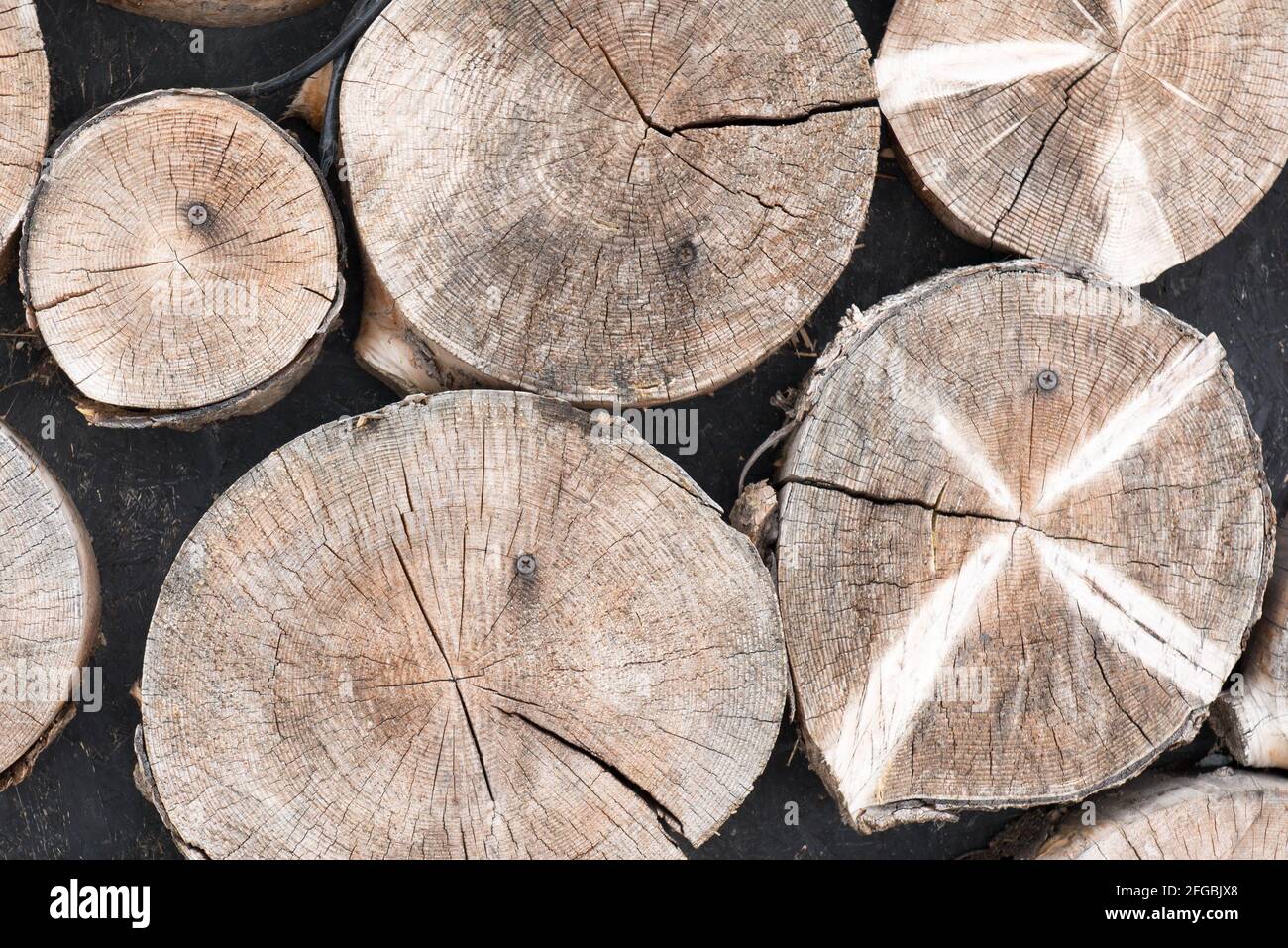 painted round logs are made by a wall Stock Photo - Alamy