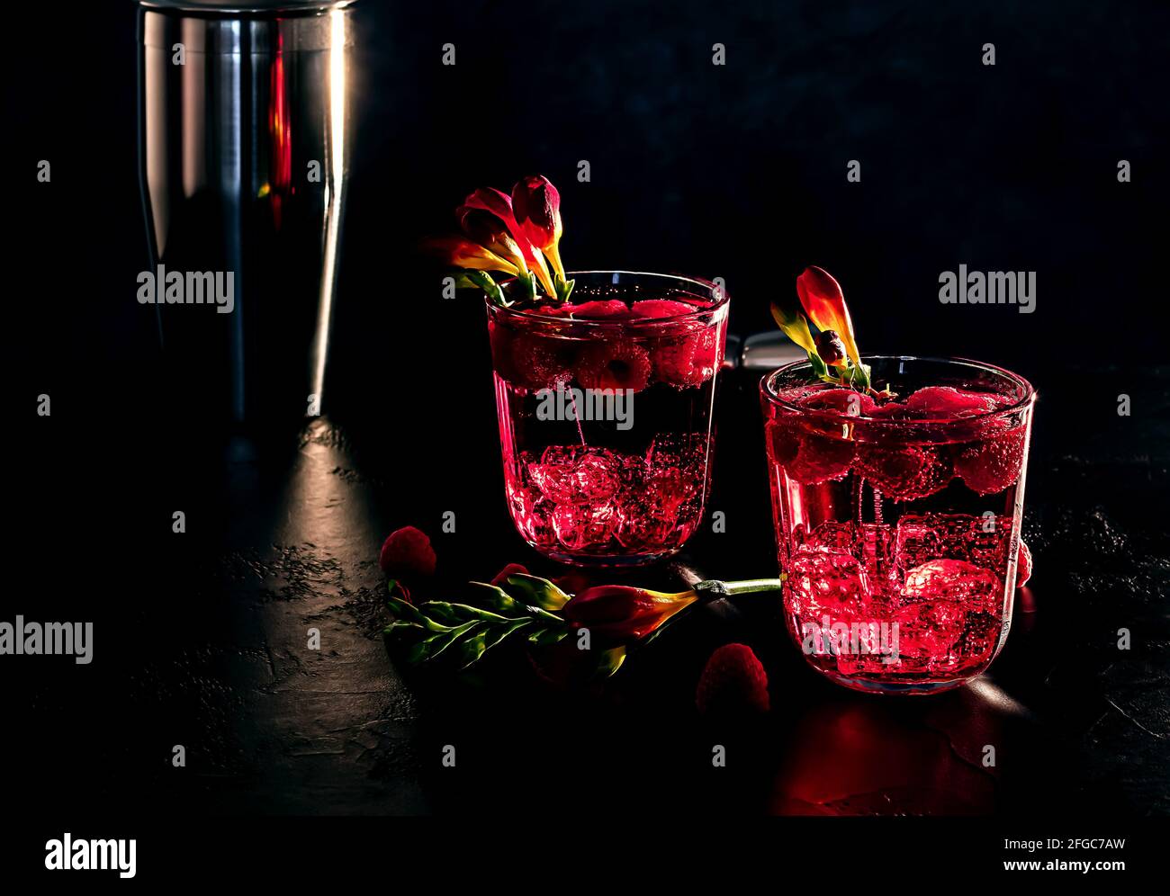 Raspberry alcoholic cocktail with liqueur, vodka, ice, and soda water ...