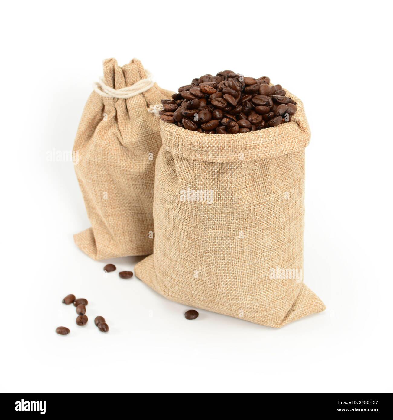 Coffee beans. Two jute burlack sacks with hard roasted coffee beans ...