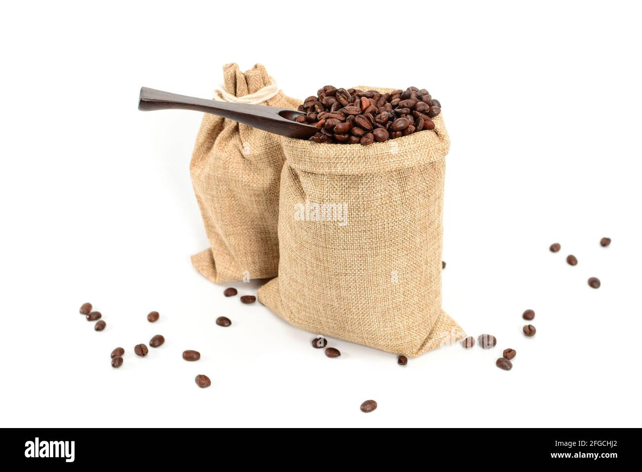 Coffee beans. Two jute burlack sacks with hard roasted coffee beans and ...