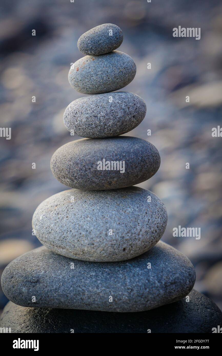 Stone piles made along a beach and the sea in the background Stock ...