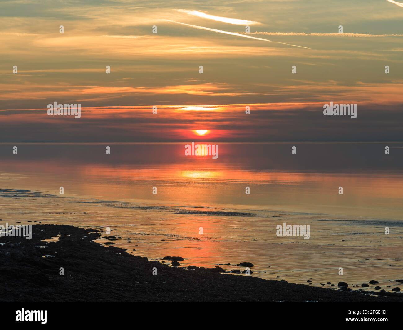Multiple colours reflecting onto a calm sea Stock Photo - Alamy