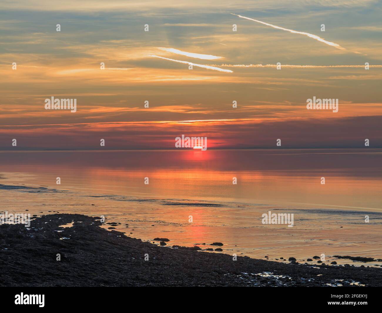 Multiple colours reflecting onto a calm sea Stock Photo - Alamy
