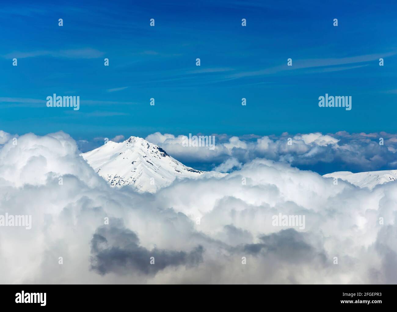 Aerial view of the mountain ranges. View through clouds at mountain ...