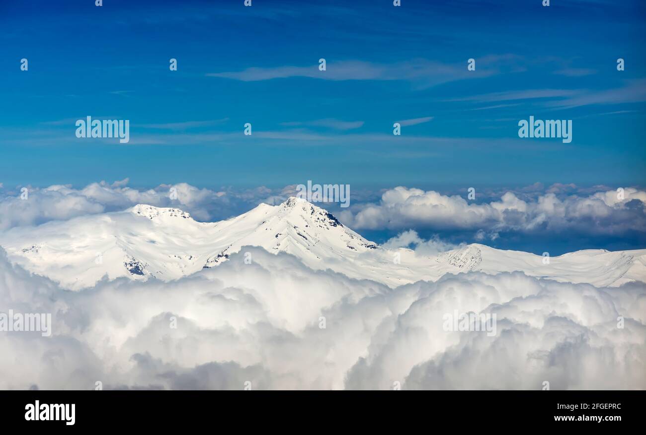 Aerial view of the mountain ranges. View through clouds at mountain ...