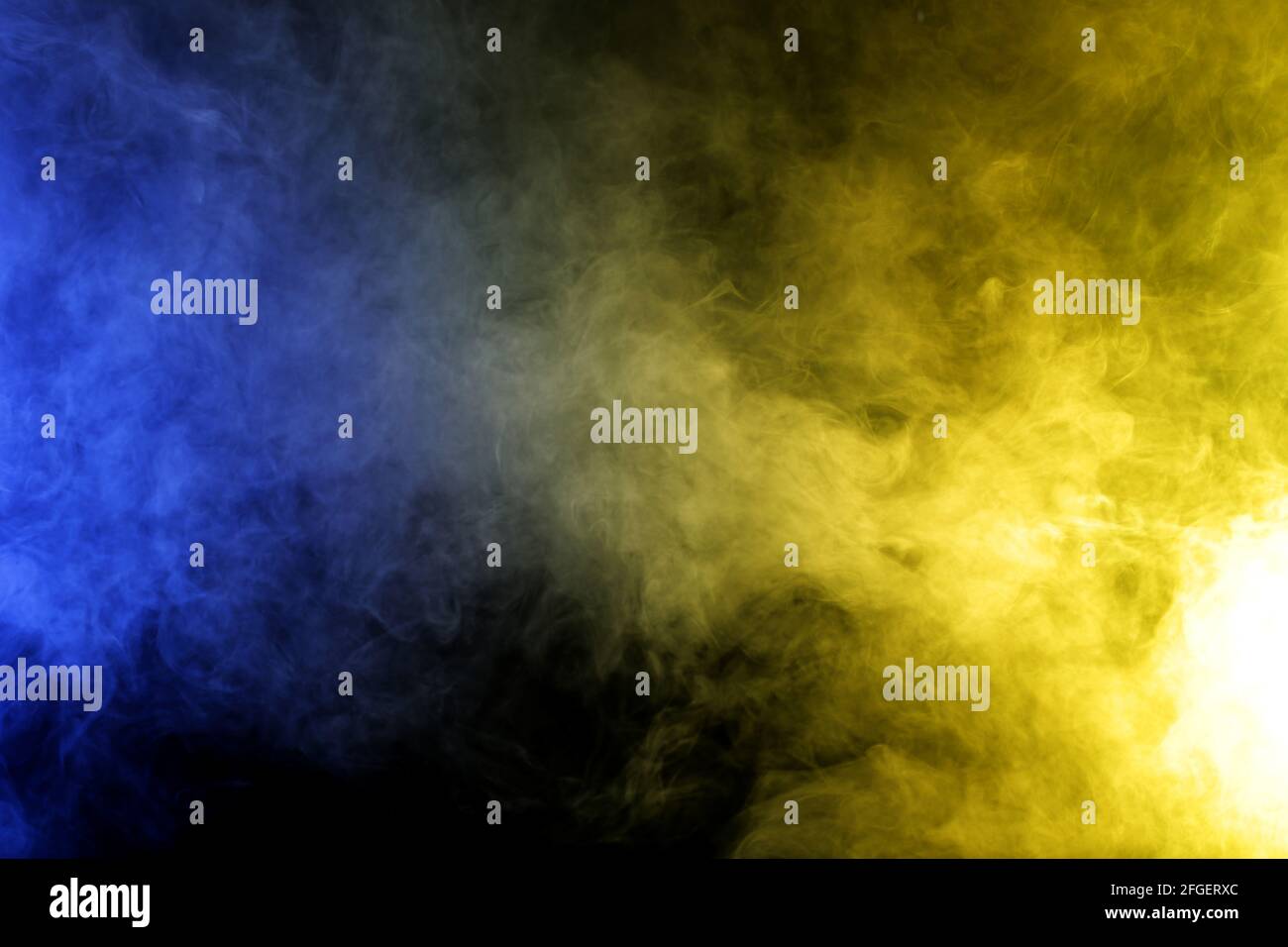 Smoke in blue yellow light on black background in darkness Stock Photo ...