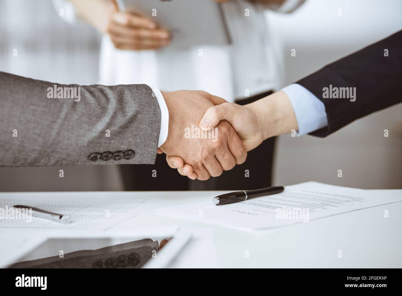Business people shaking hands finishing contract signing, close-up ...