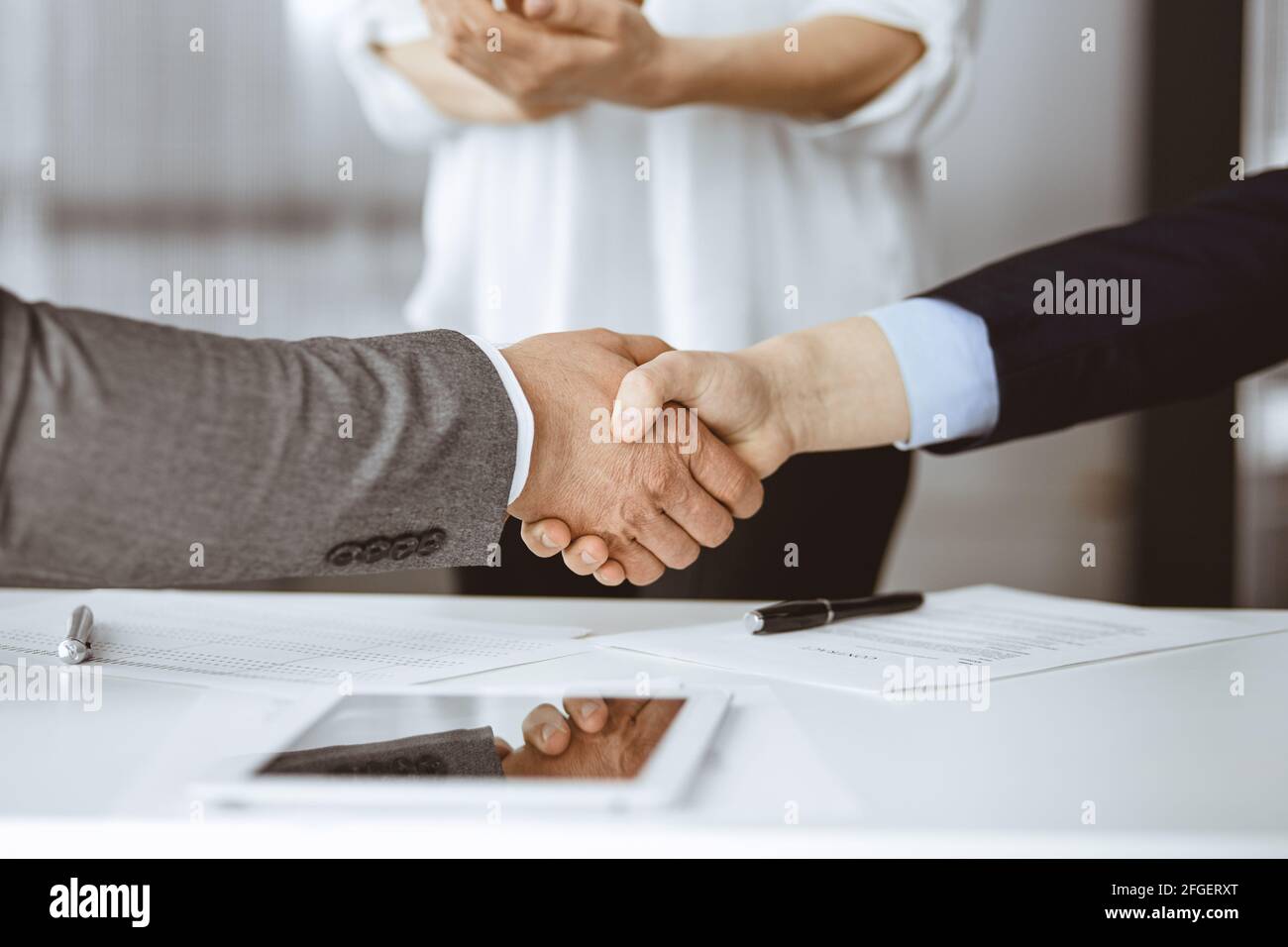 Business people shaking hands finishing contract signing, close-up ...