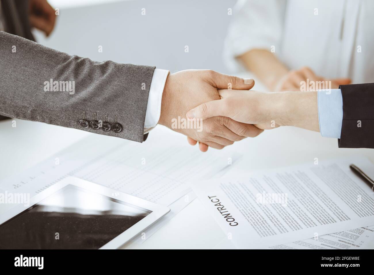 Business people shaking hands finishing contract signing, close-up ...