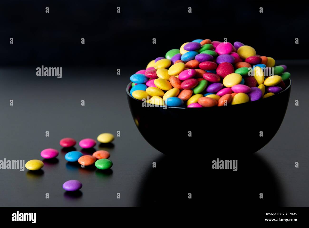 A bowl full of colorful round candies Stock Photo - Alamy