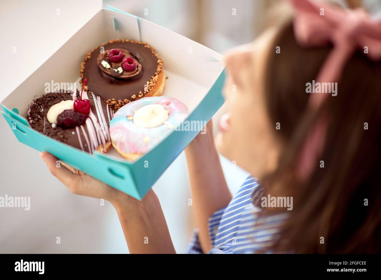 A beautiful girl in a pleasant atmosphere in a pastry shop is so happy ...