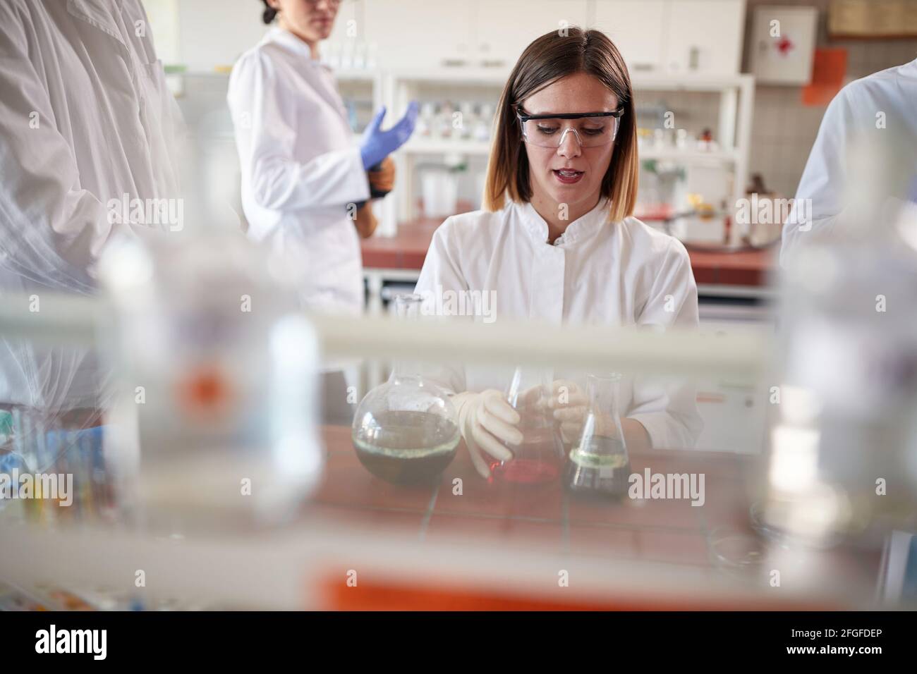Young scientists work in a sterile laboratory environment. Science ...