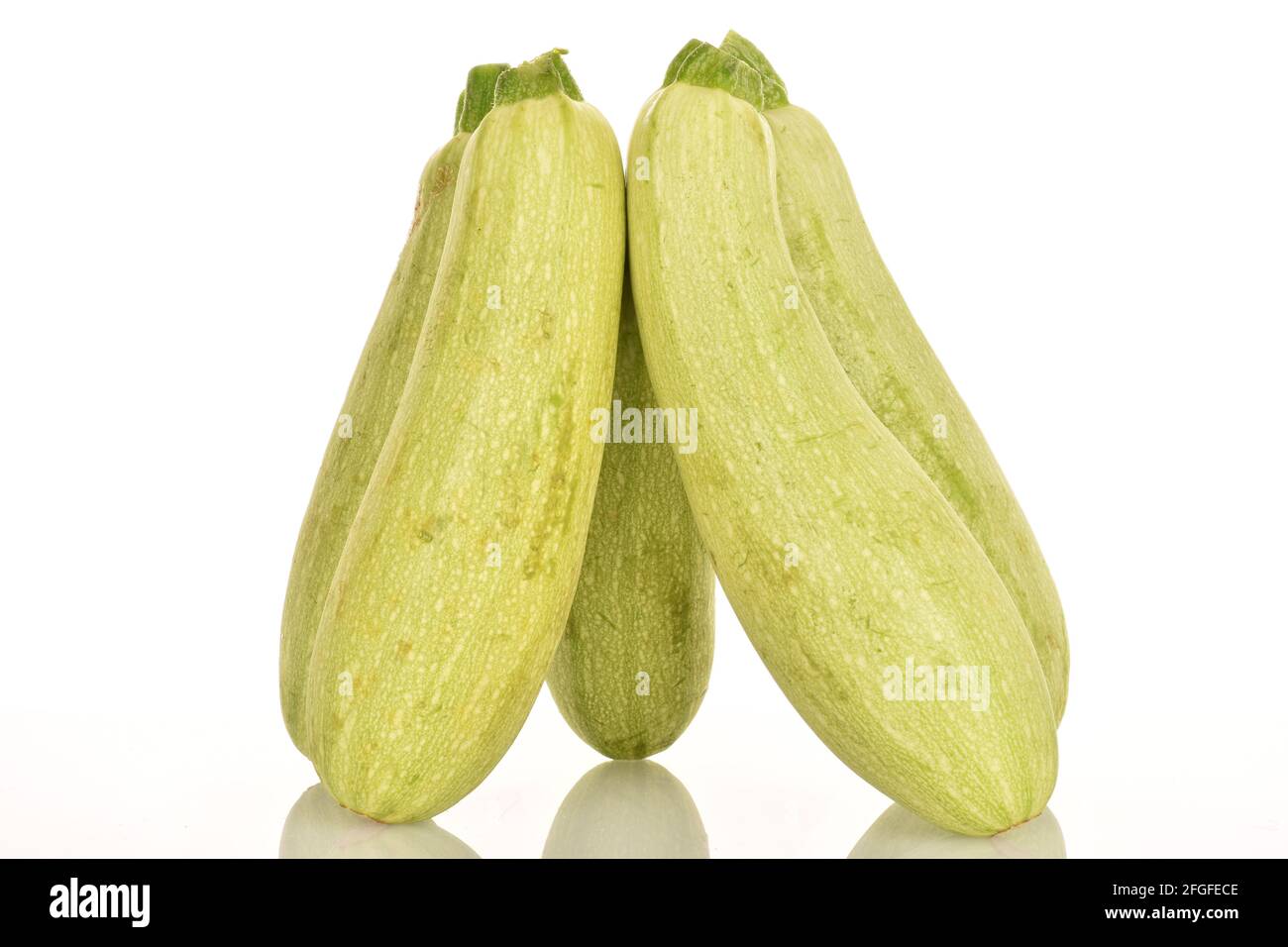 Three ripe fresh organic vegetable marrow, close-up, on a white ...