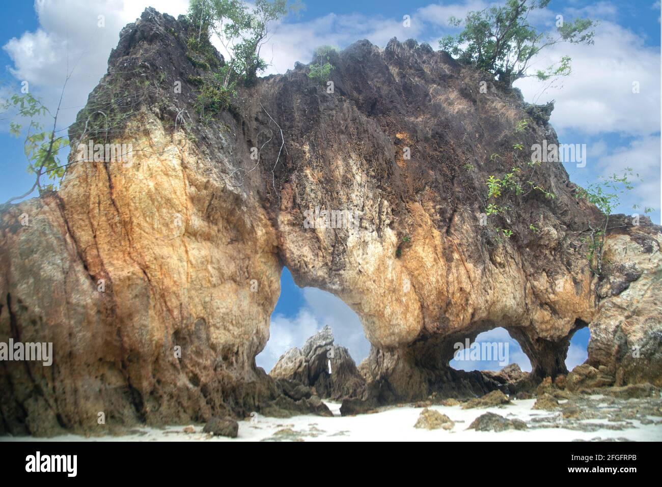 A rocky beach with a view of the rock with holes and the sea. Rocky ...