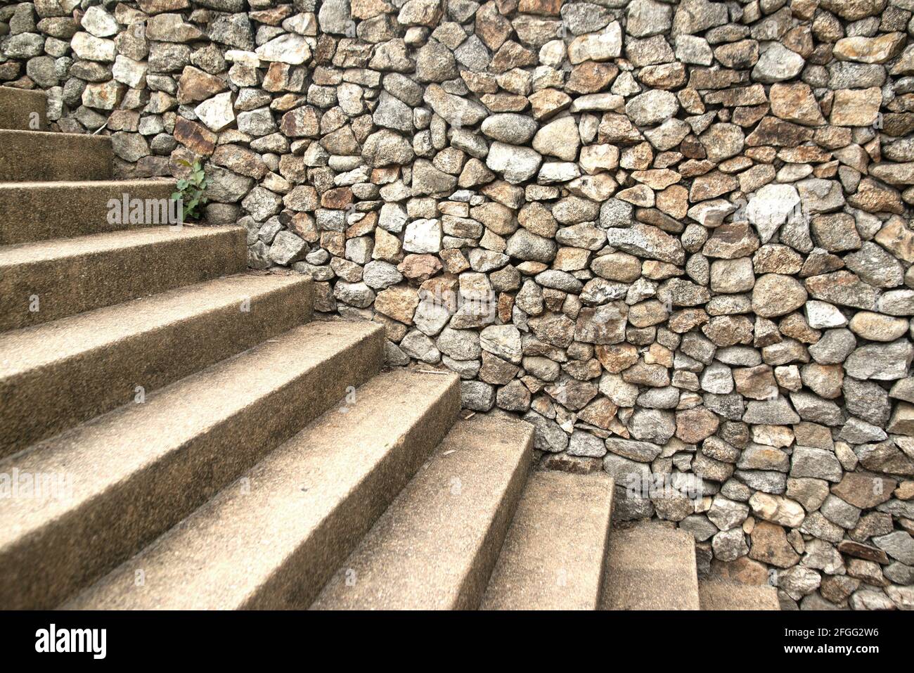 Texture and background wall gray stone with staircase part of the stone ...