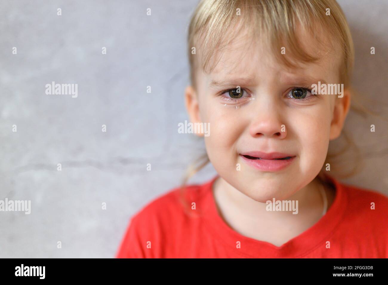 kid crying. the face of a cute little upset four year old baby boy in ...