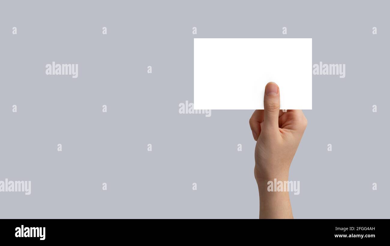 Hand holding white card on isolated background Stock Photo - Alamy